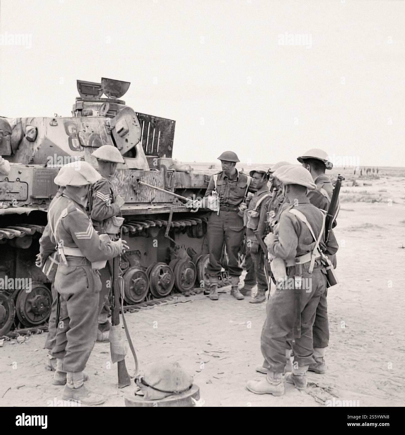 British Troops are shown the effects of anti-tank rounds on a knocked ...