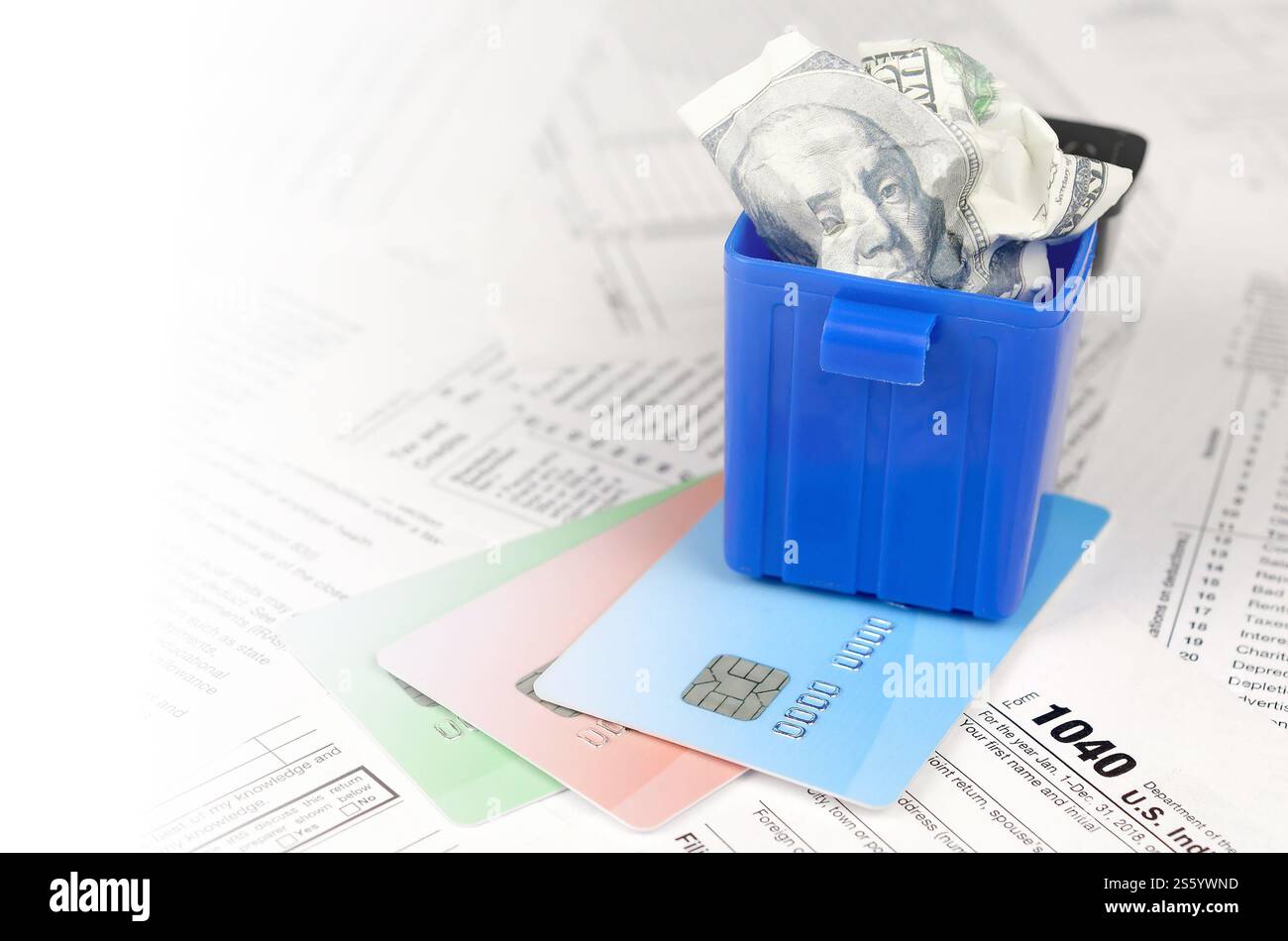 1040 Individual income tax return form and crumpled hundred dollar bill ...