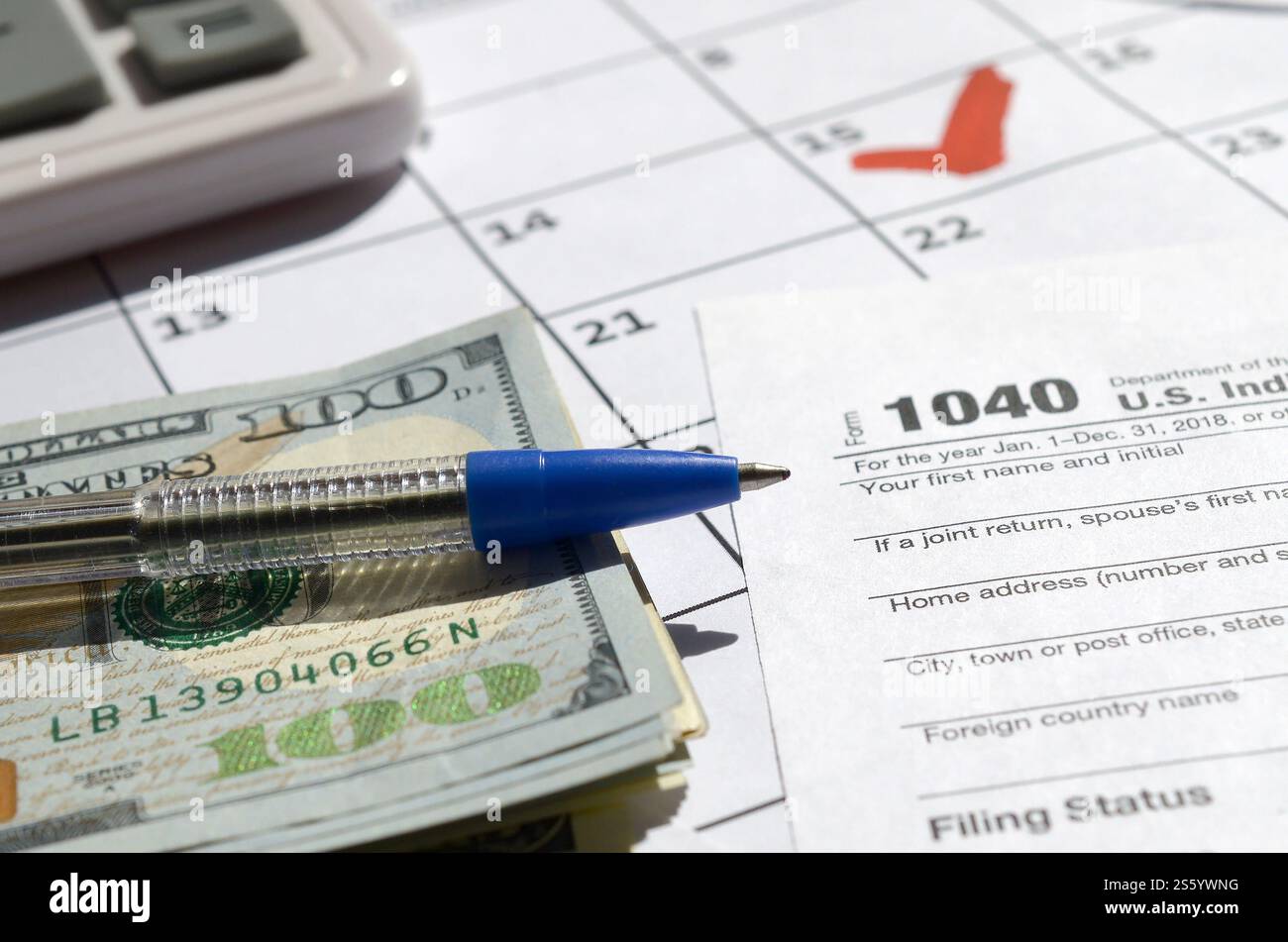 1040 Individual Income Tax Return blank with dollar bills, calculator ...