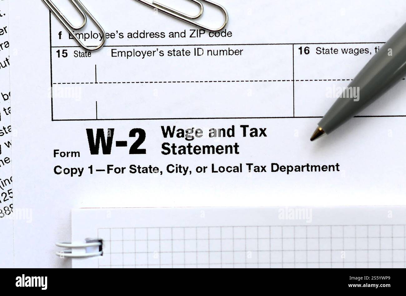 The pen and notebook on the tax form W-2 Wage and Tax Statement. The time to pay taxes Stock ...