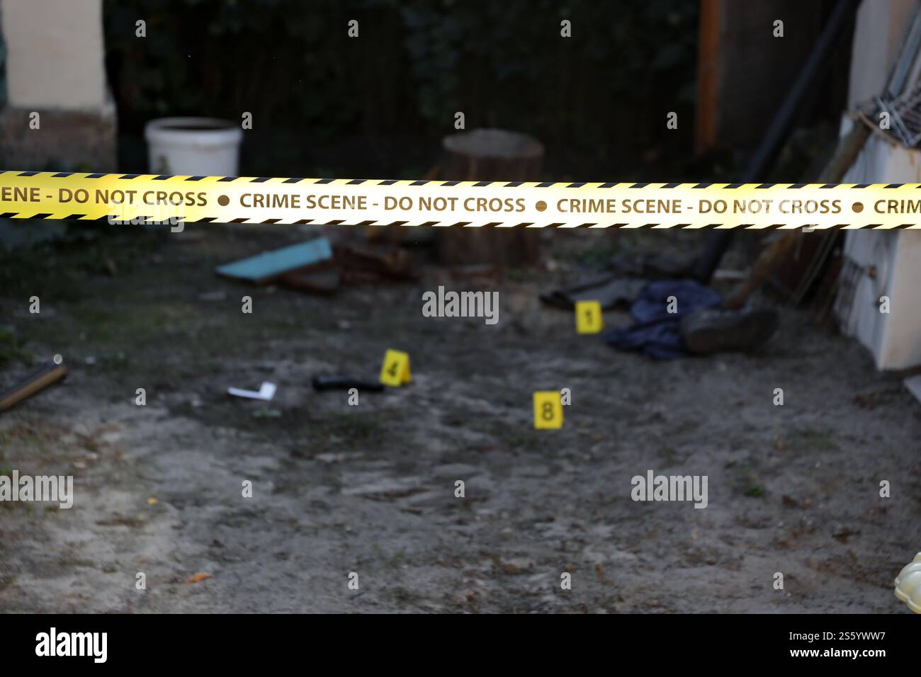 Crime scene tape for covering the area cordon. Yellow tape with blurred forensic law enforcement ...