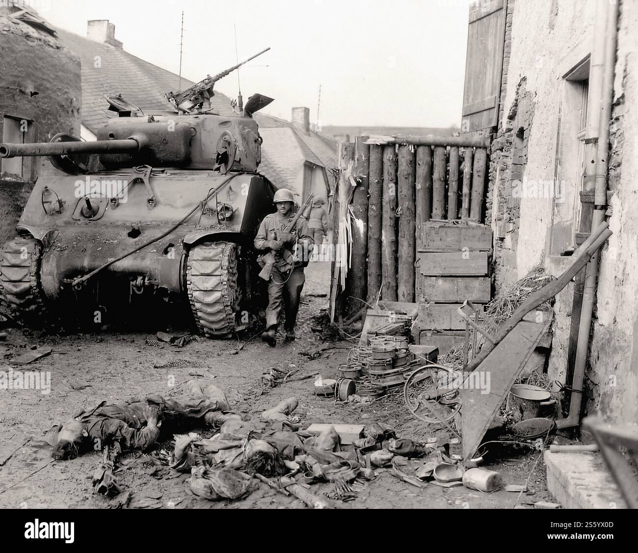 Knocked out M4 Sherman and in the foregrount dead german soldiers ...