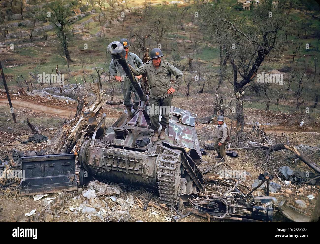 U.S. soldiers inspecting a German SPG Marder III taken off the road to ...