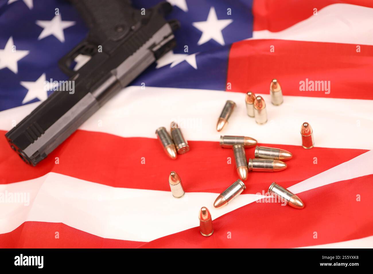 Many yellow 9mm bullets and gun on United States flag. Concept of gun ...