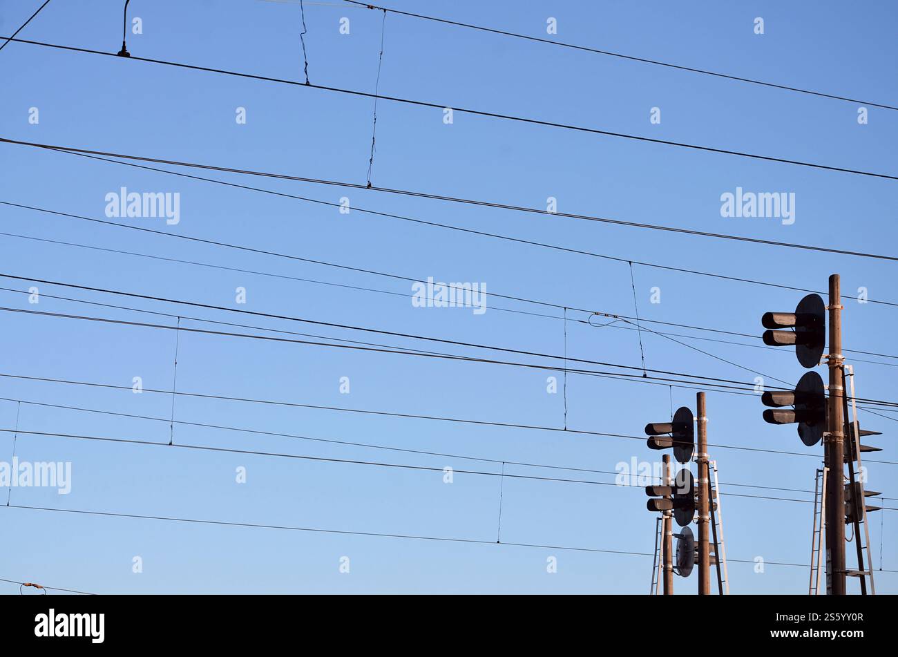 Railroad traffic light against clear blue sky, Contact wire. High ...