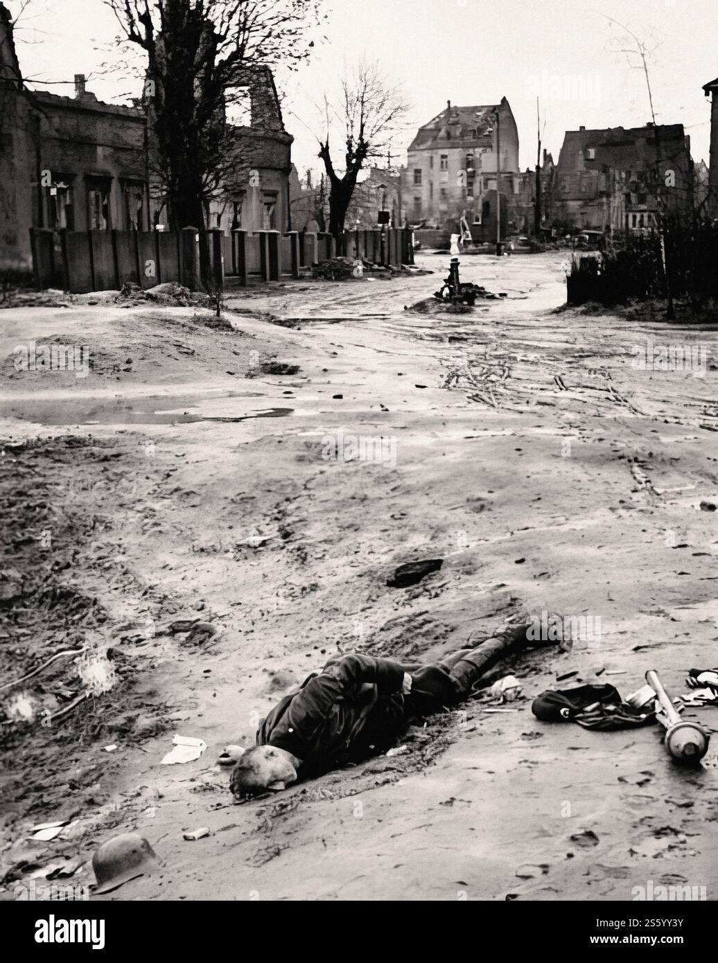 A dead German soldier lies next to a Panzerfaust in a town in north ...