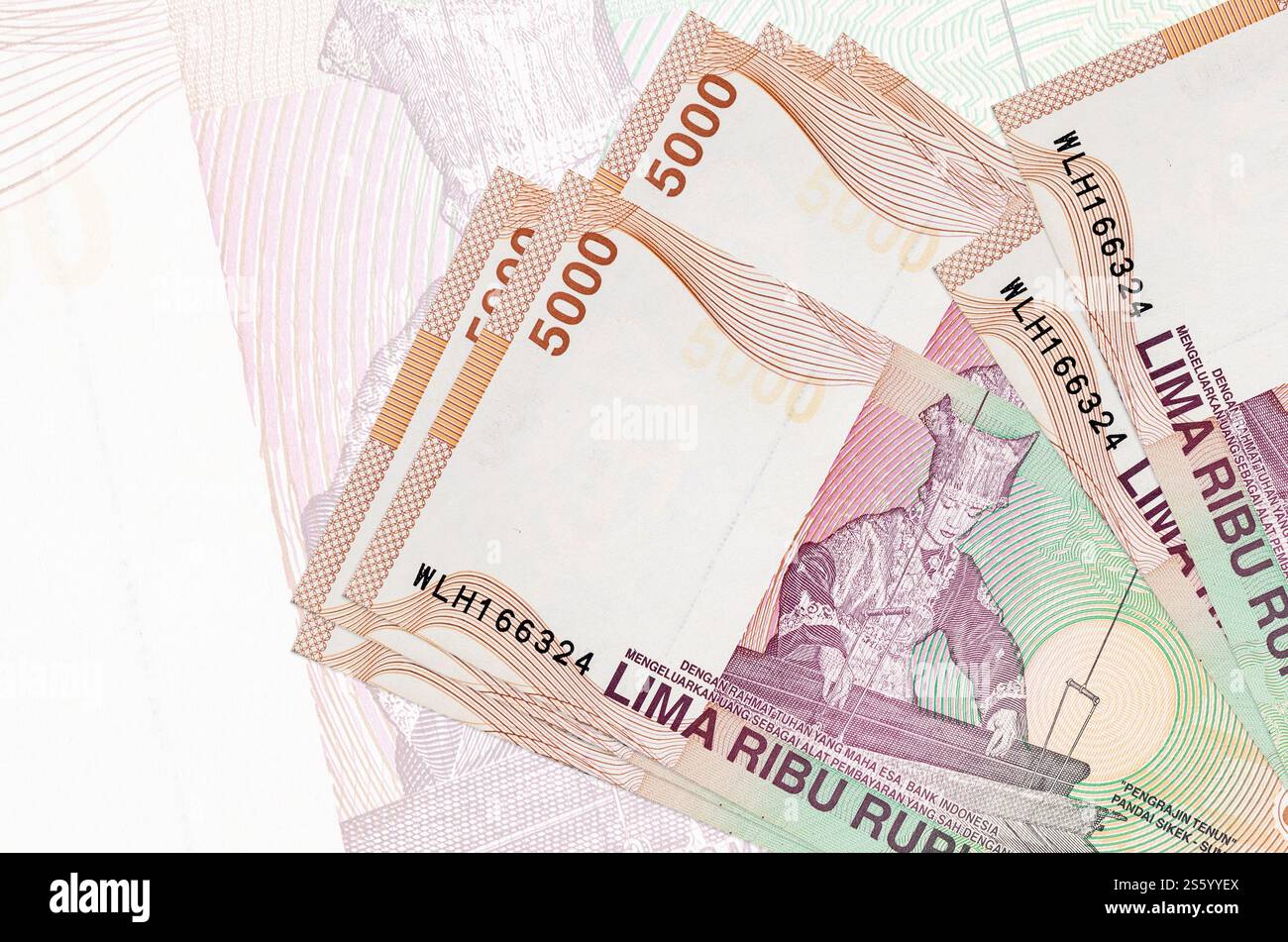 5000 Indonesian rupiah bills lies in stack on background of big semi ...