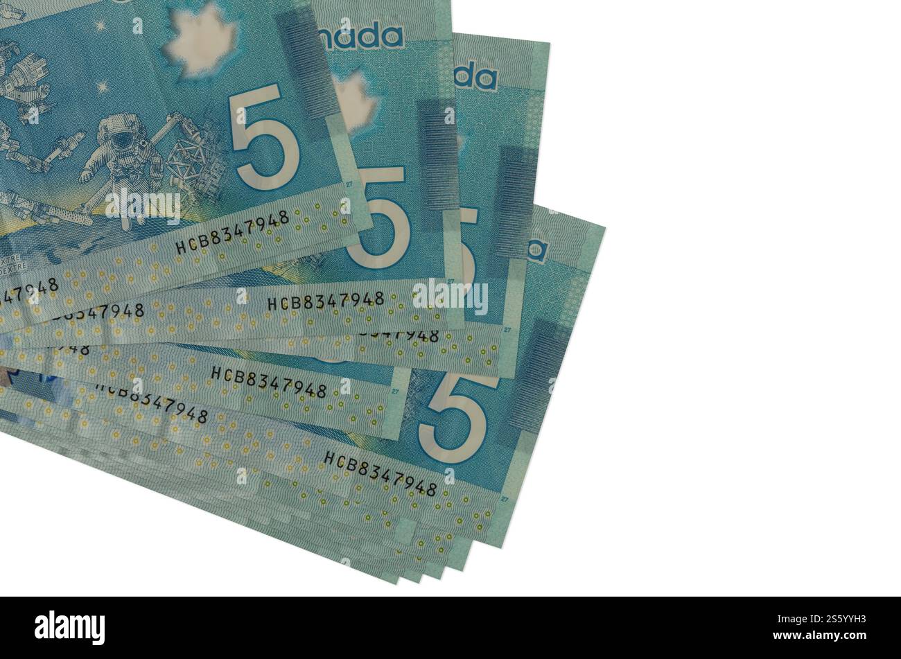 5 Canadian dollars bills lies in small bunch or pack isolated on white ...