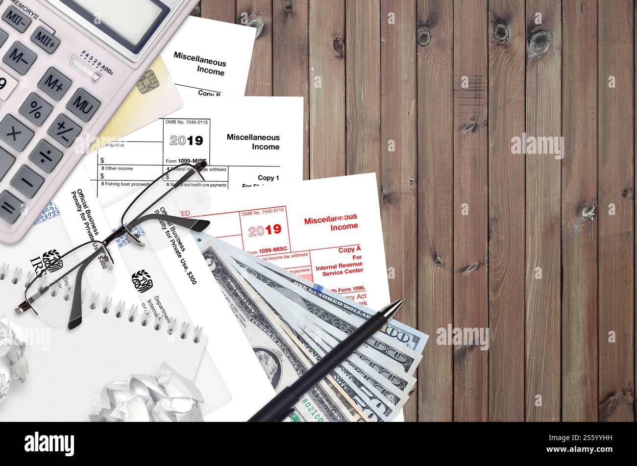 IRS form 1099-MISC Miscellaneous income lies on flat lay office table ...