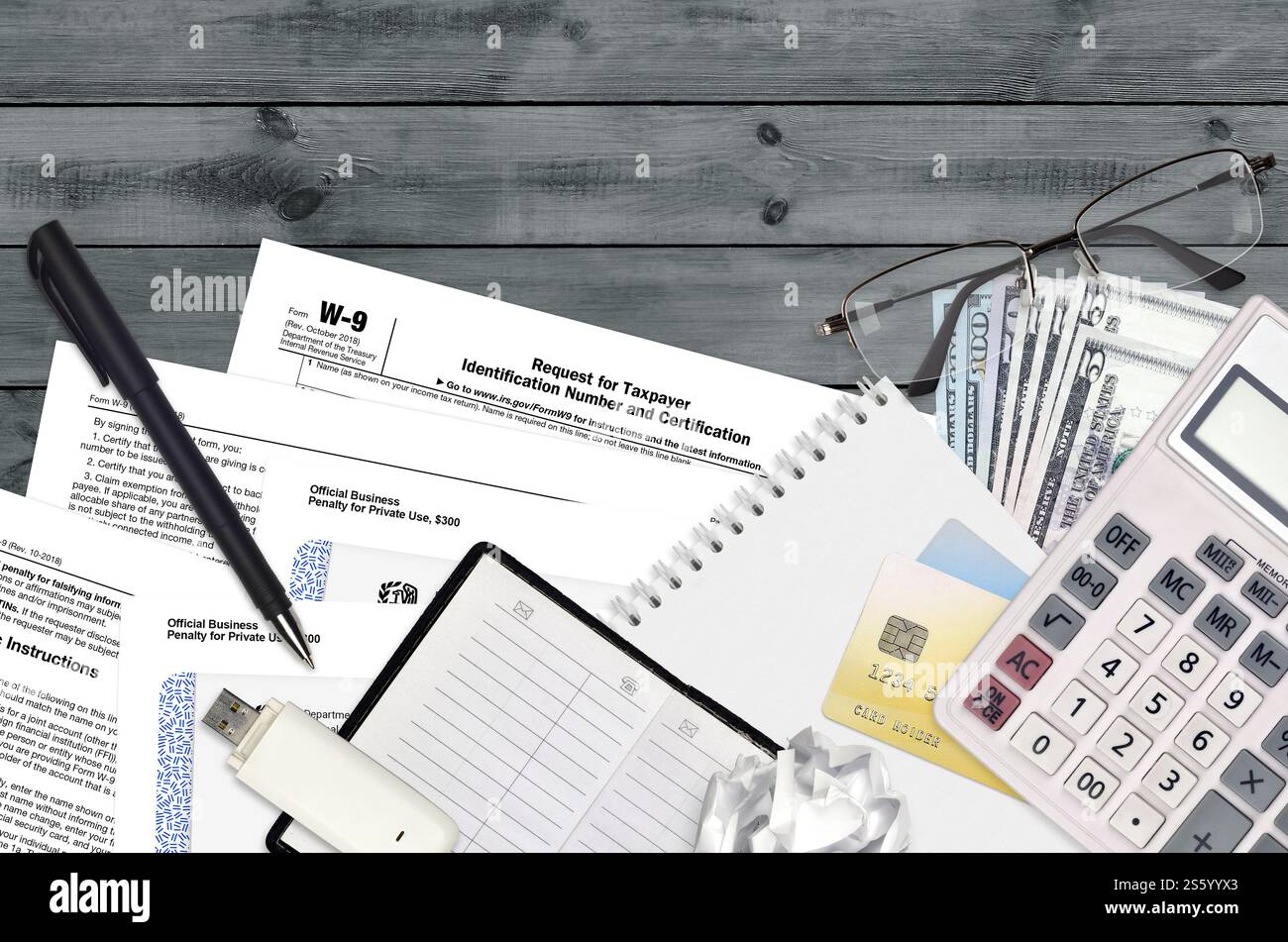 IRS form W-9 Request for taxpayer identification number and certification lies on flat lay ...