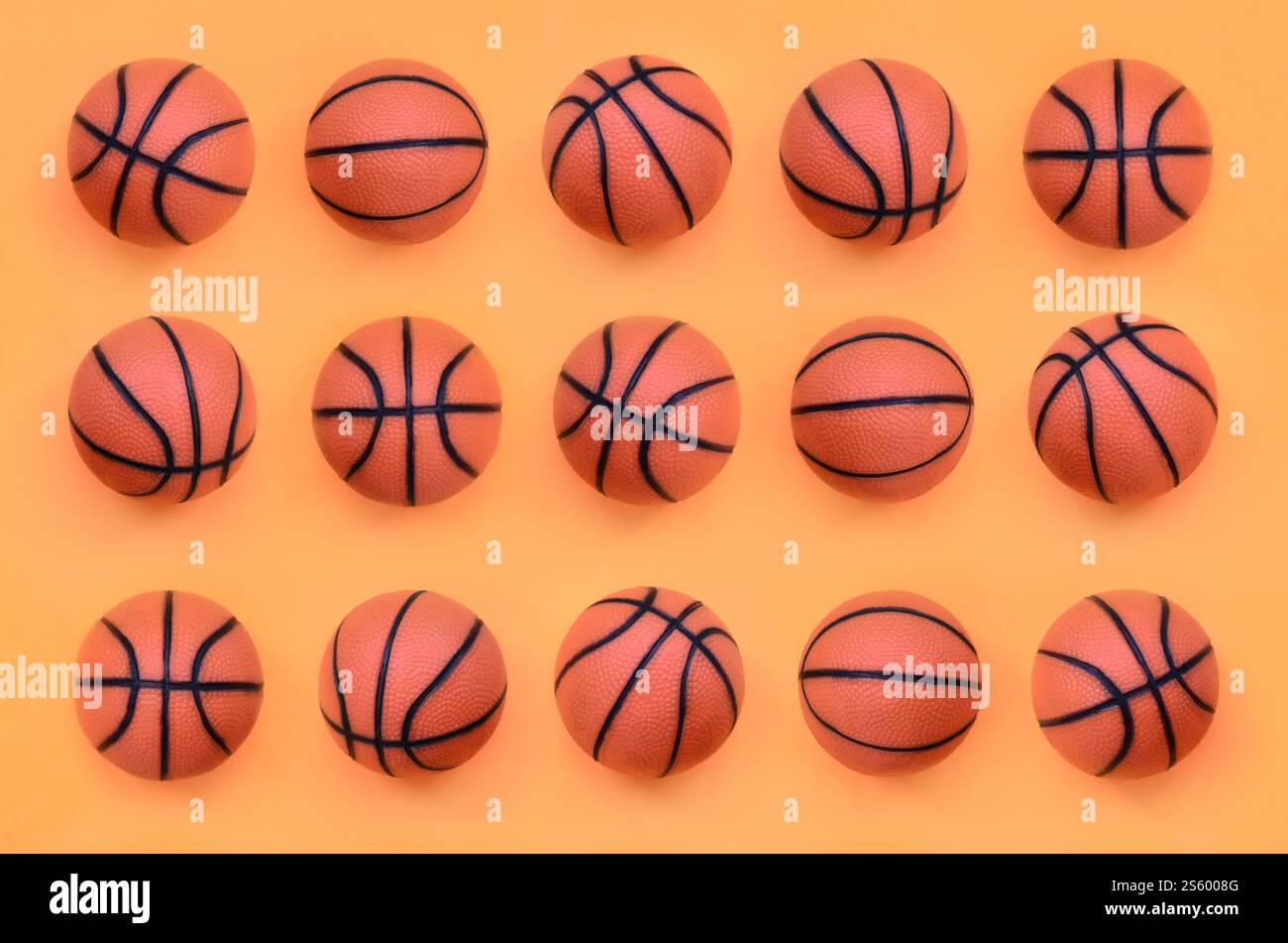 Many small orange balls for basketball sport game lies on texture ...