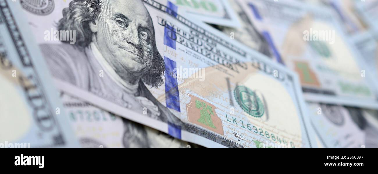 A large number of US dollar bills of a new design with a blue stripe in ...