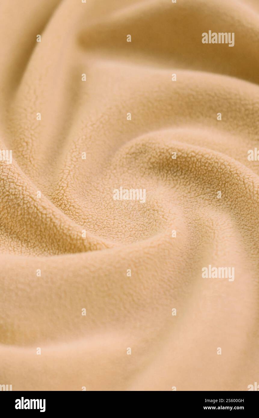 The blanket of furry orange fleece fabric. A background of light orange ...