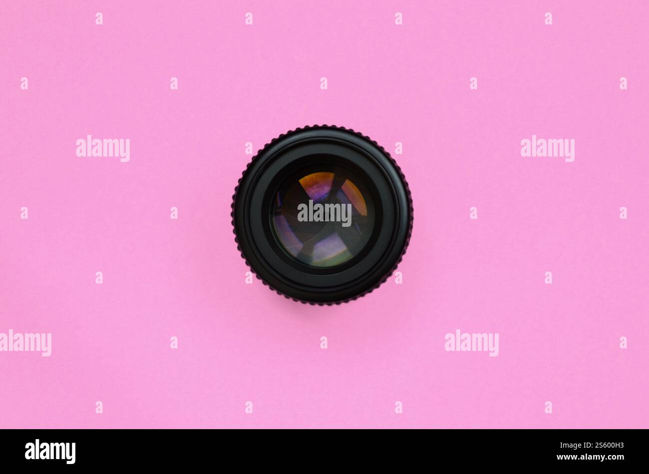 Camera lens with a closed aperture lie on texture background of fashion ...
