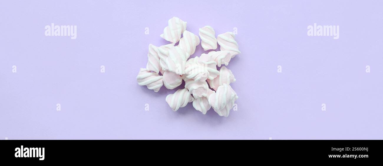 Colorful marshmallow laid out on violet paper background. pastel ...