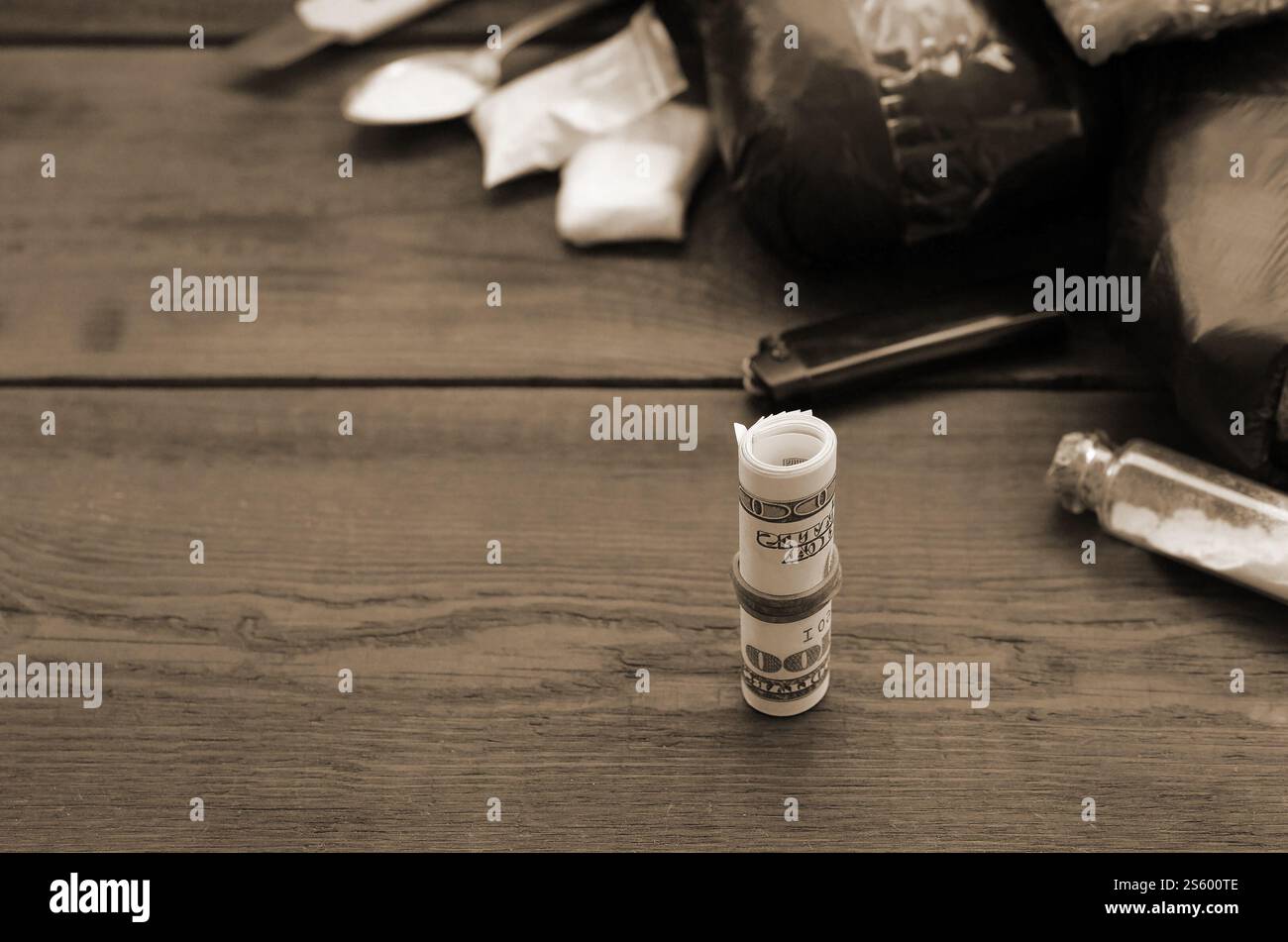 Roll of hundred dollar bills on background of narcotic drug dealer ...