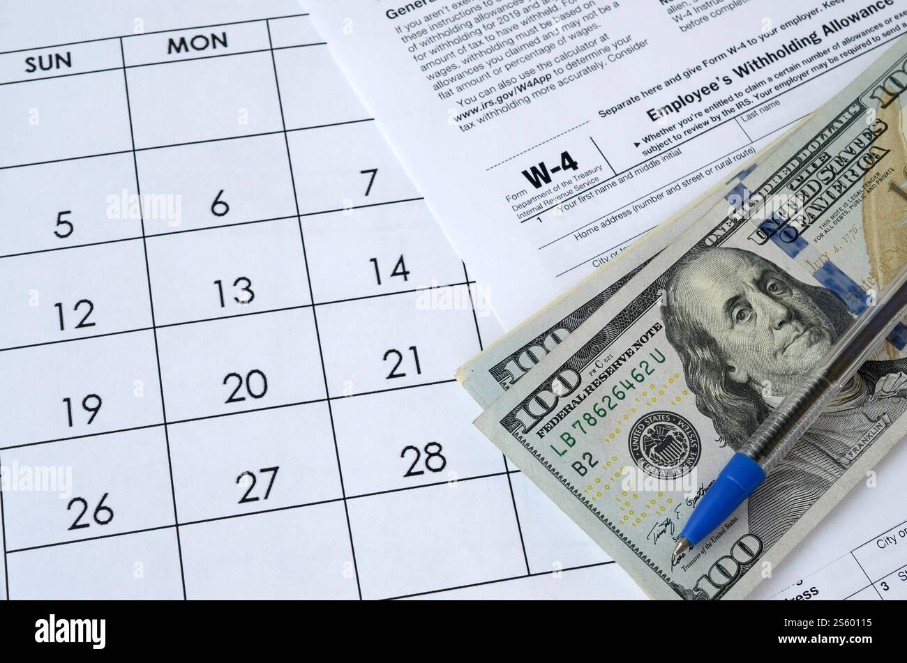 Form W-4 Employees withholding allowance certificate and blue pen with ...