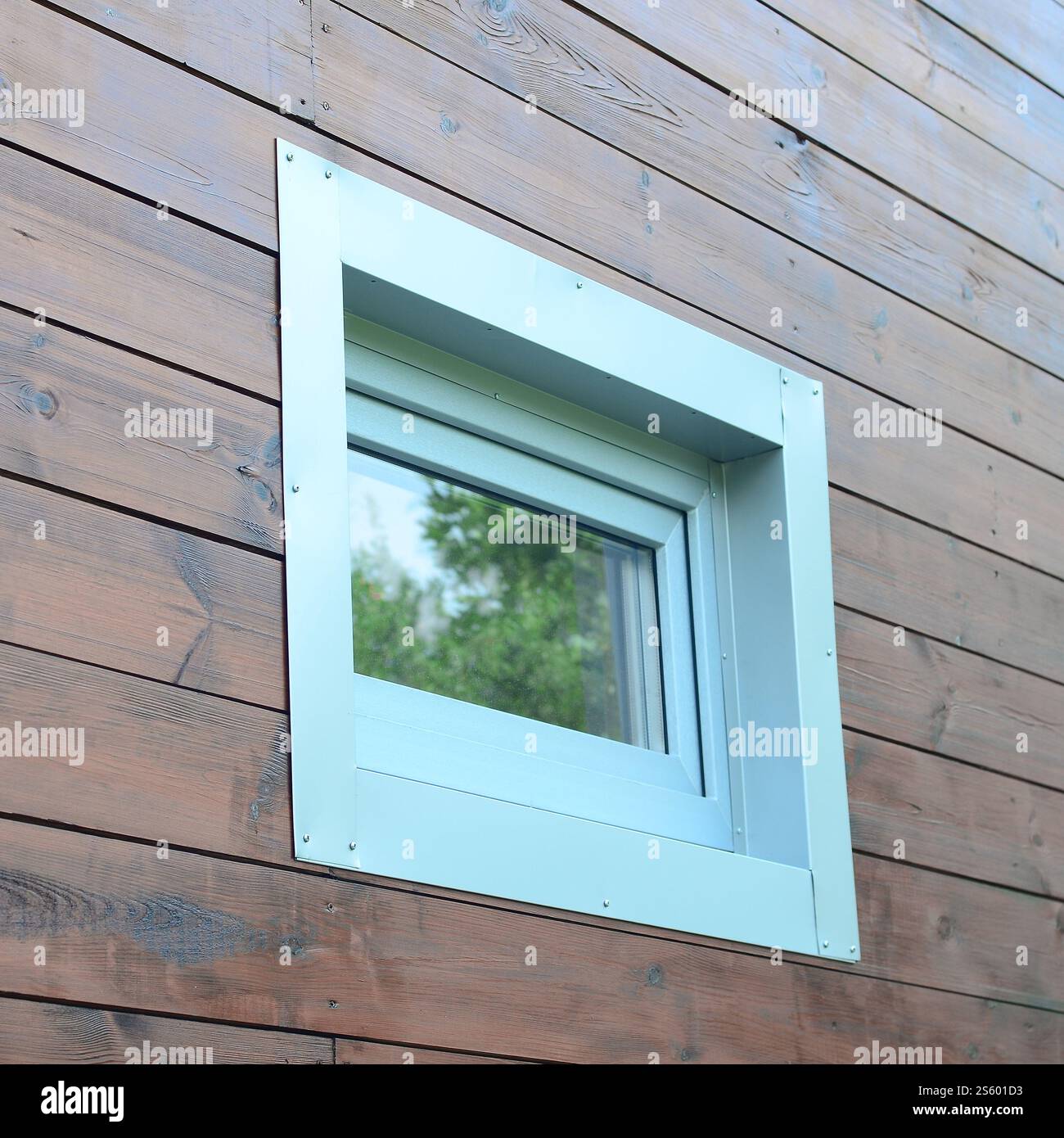 Plastic PVC window in modern passive wooden house facade wall. PVC ...