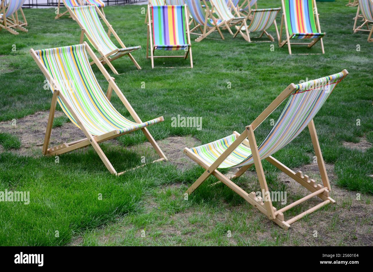 Chaise lounges on a lawn. Rest in the festival, on vacation. Garden ...