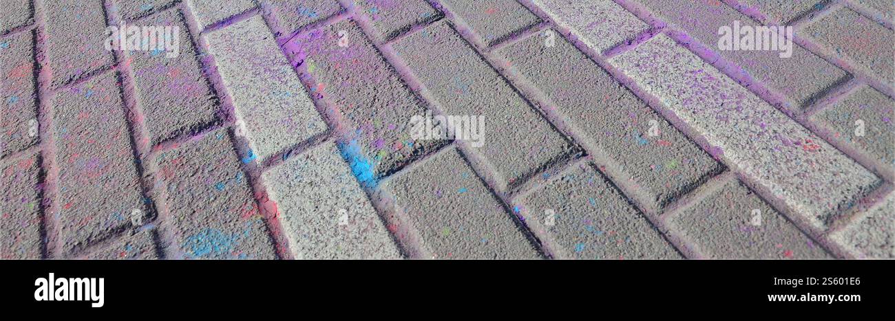 Multi colored earth, paving slabs, powder coated with dry colors at the Holi festival close up ...