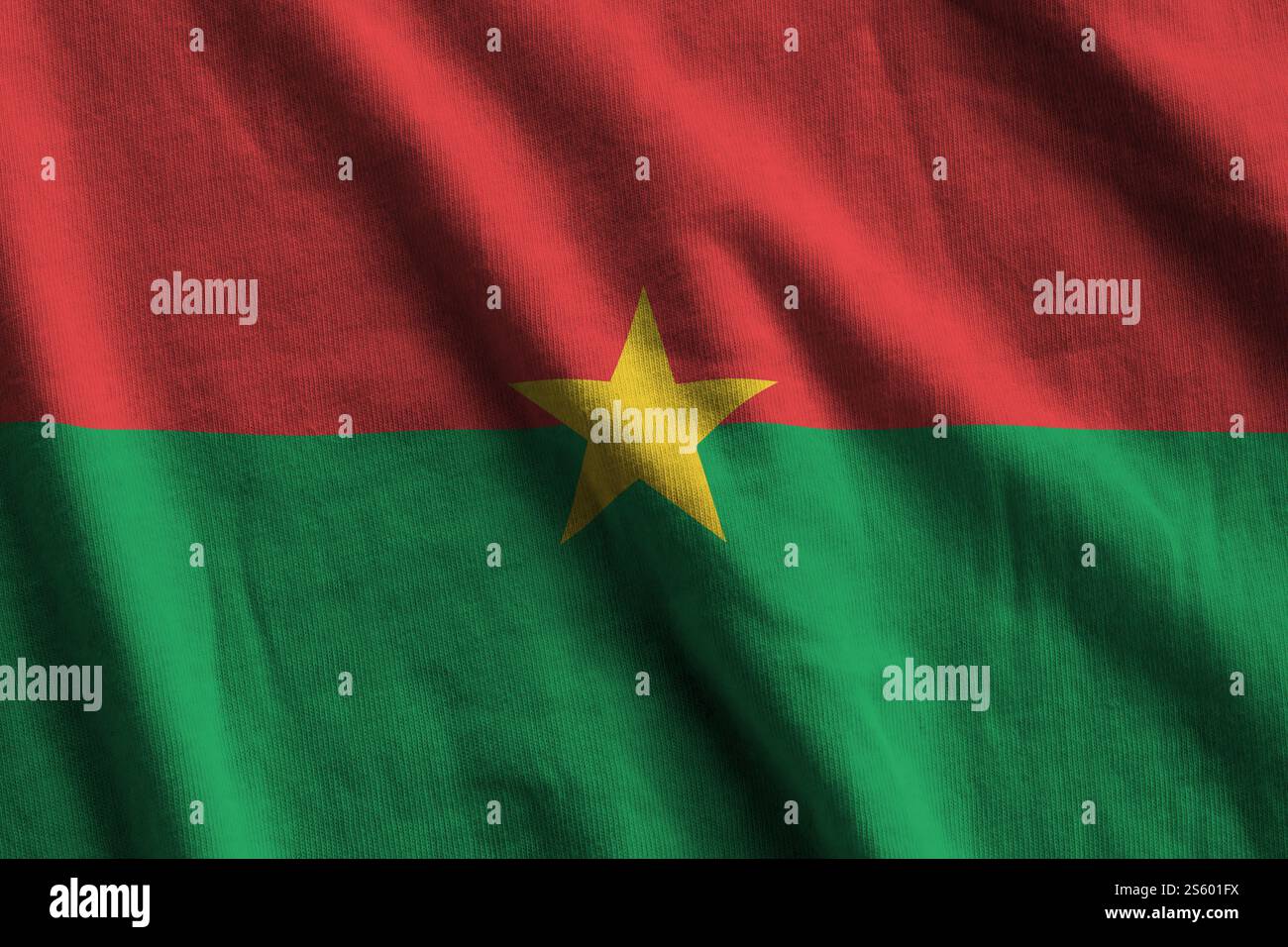 Burkina Faso flag with big folds waving close up under the studio light ...