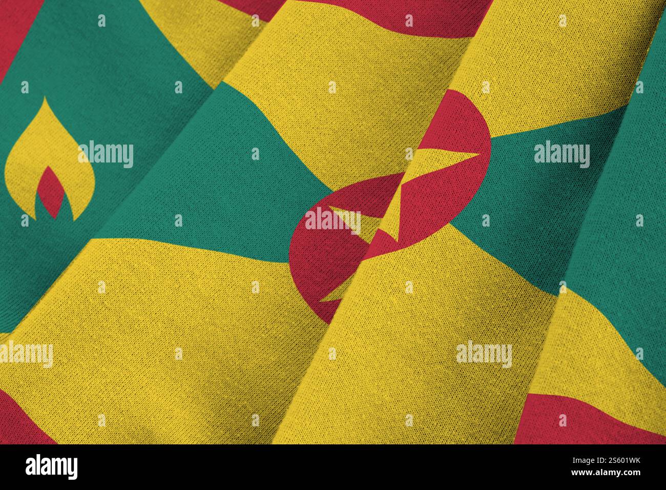 Grenada flag with big folds waving close up under the studio light ...