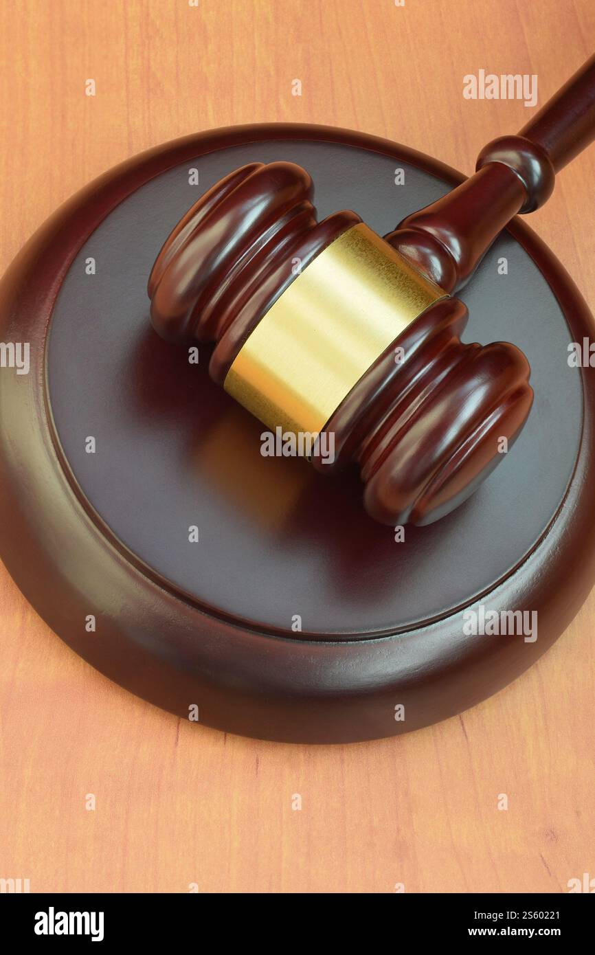 Justice mallet on wooden desk in a courtroom during a judicial trial. Law concept and empty copy ...