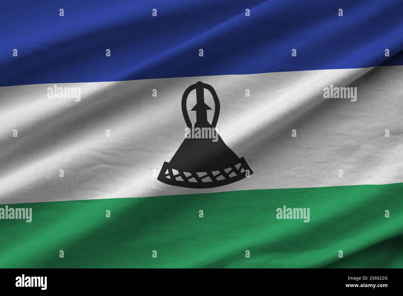 Lesotho flag with big folds waving close up under the studio light ...