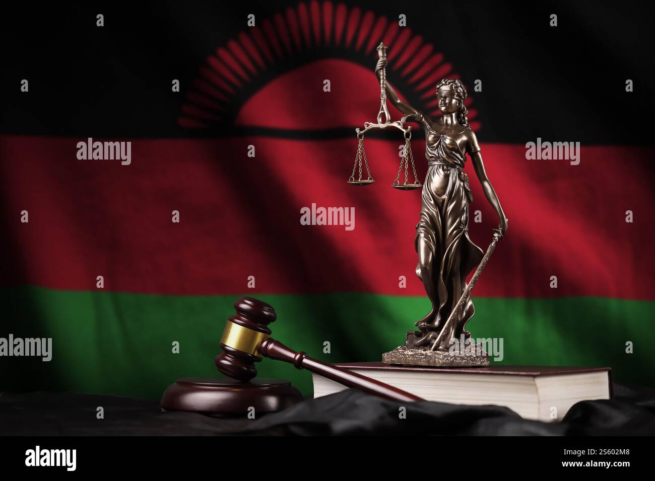 Malawi flag with statue of lady justice, constitution and judge hammer ...