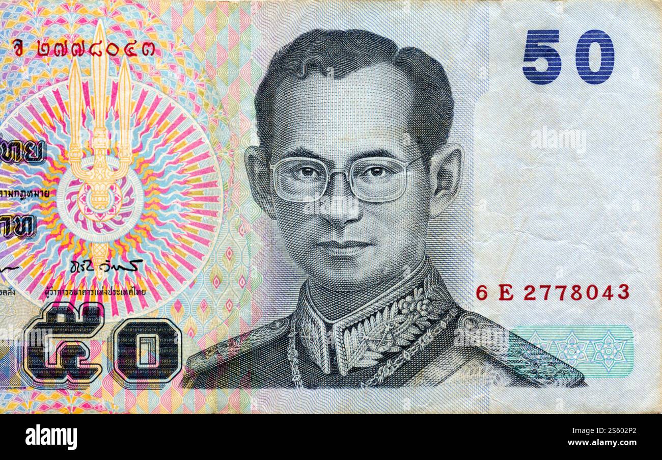 King Bhumibol Adulyadej on fragment of 50 Baht Thailand money bill close up. Bill of national ...