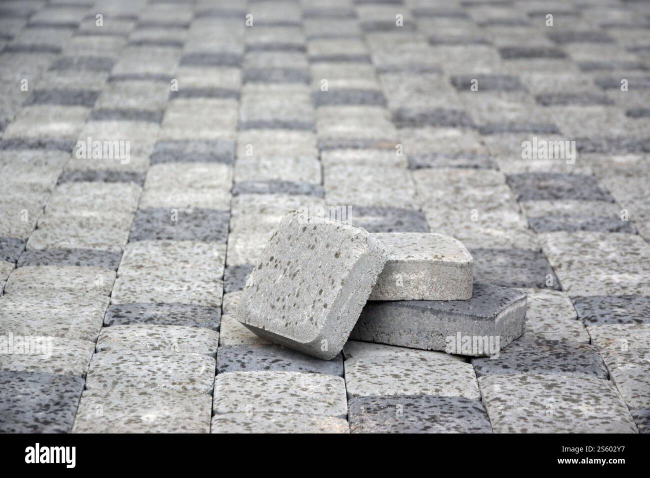 Small pile of gray walkway slabs lying in stack outdoors. Material for ...