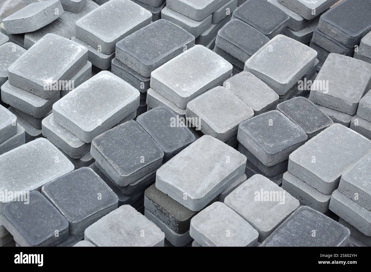 Pile of gray and dark grey walkway slab lying down outdoor. Material ...