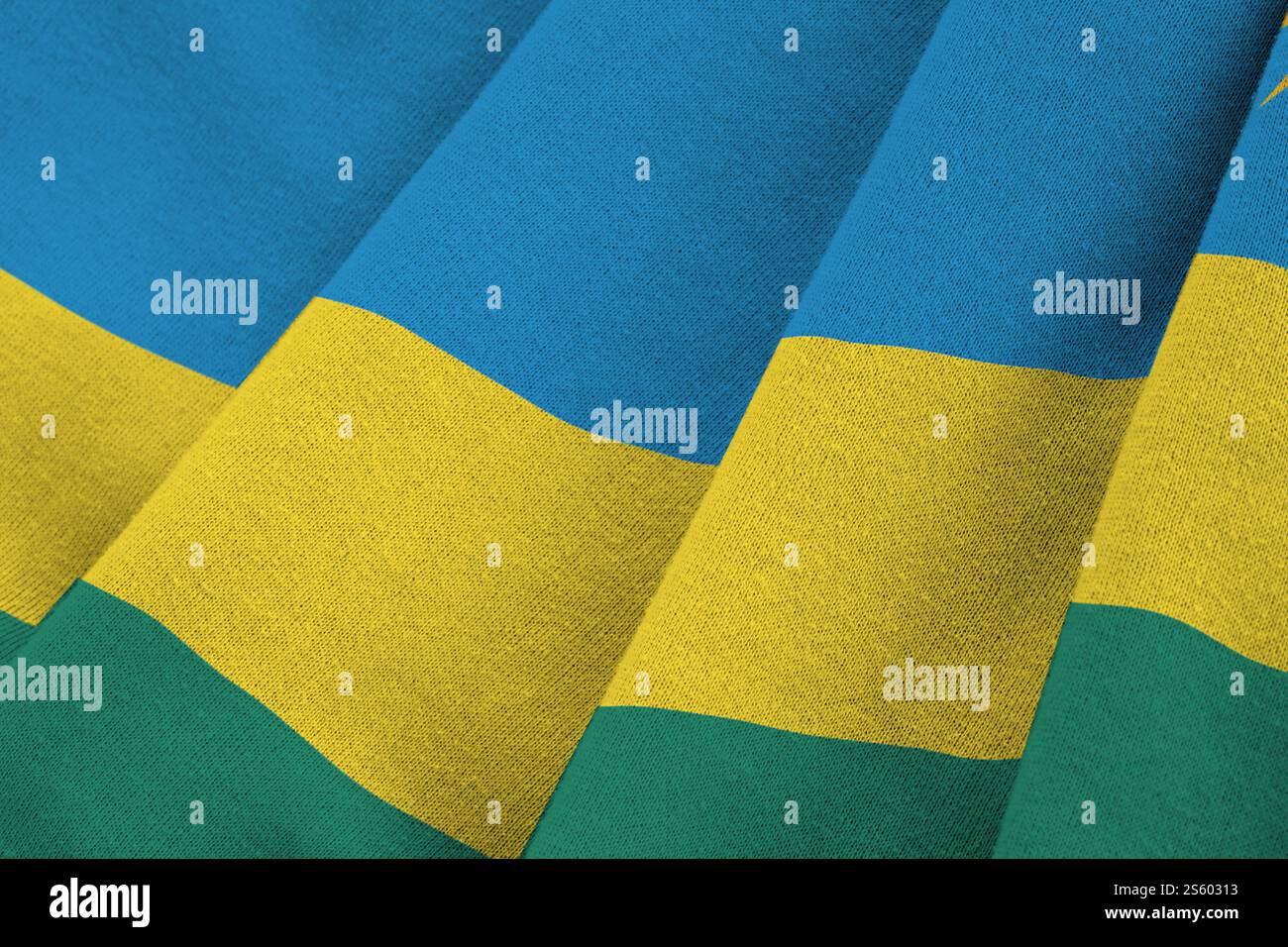 Rwanda flag with big folds waving close up under the studio light ...