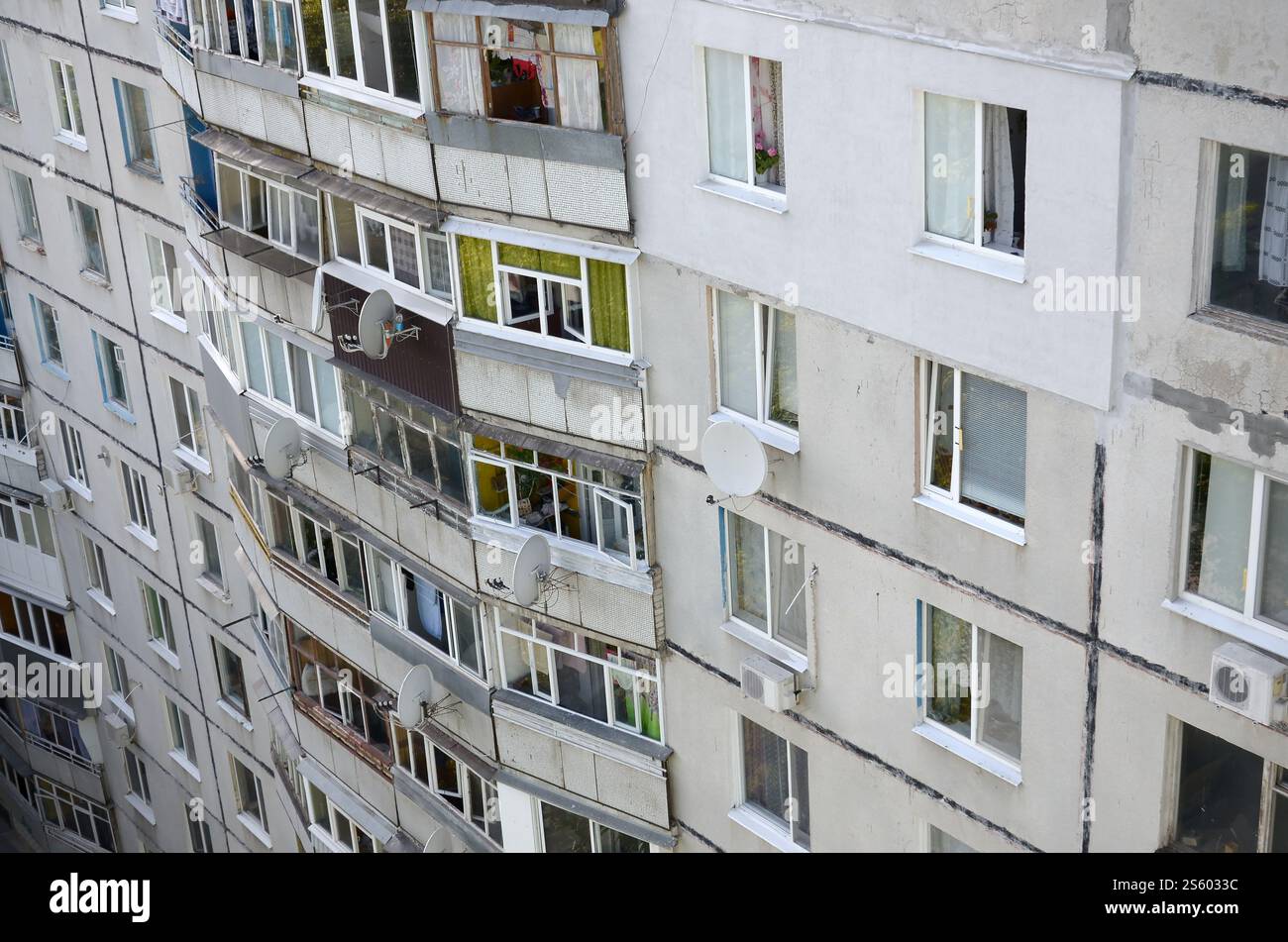 Facade of a grey multi storey soviet panel building. Russian old urban ...