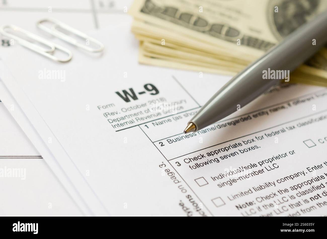 IRS Form W-9 Request for taxpayer identification number and certification blank lies with pen ...