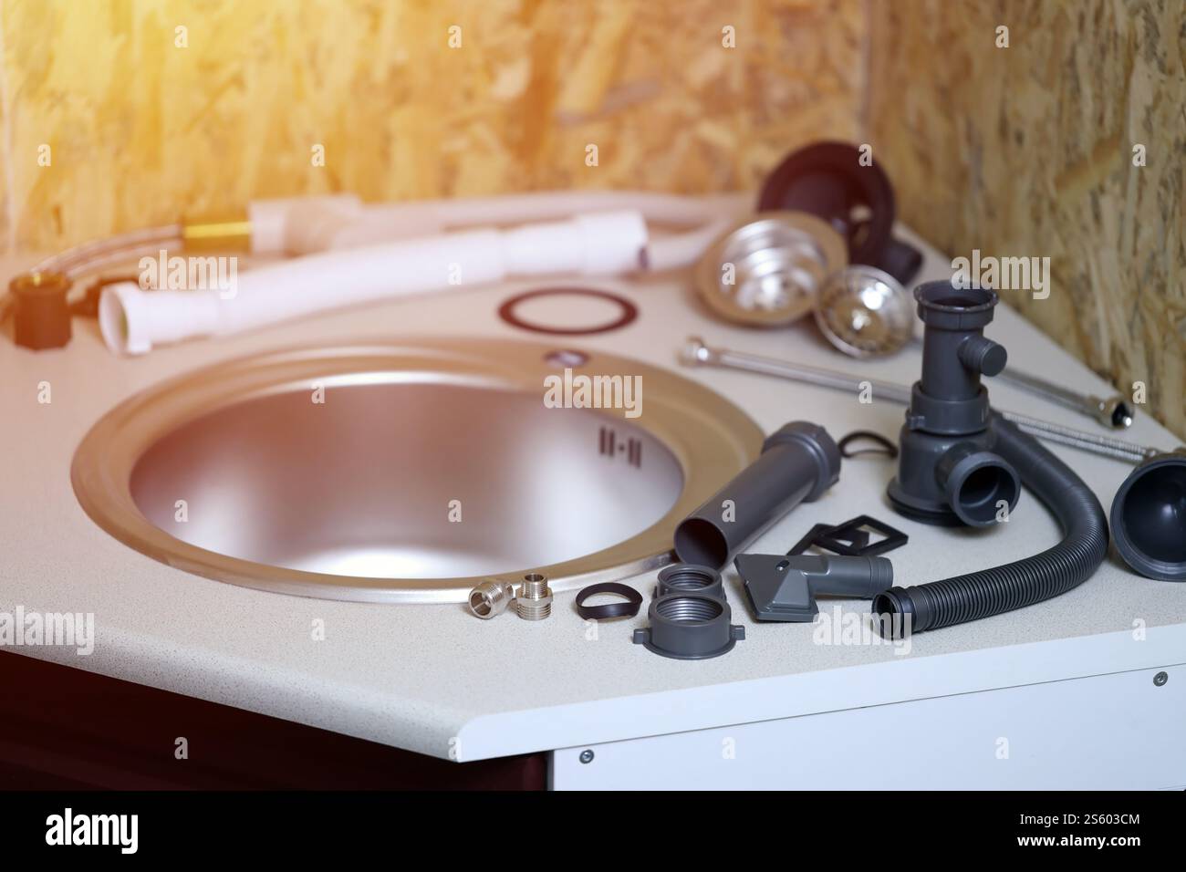 Plumbers tools and water tap ready for installation near sink on ...