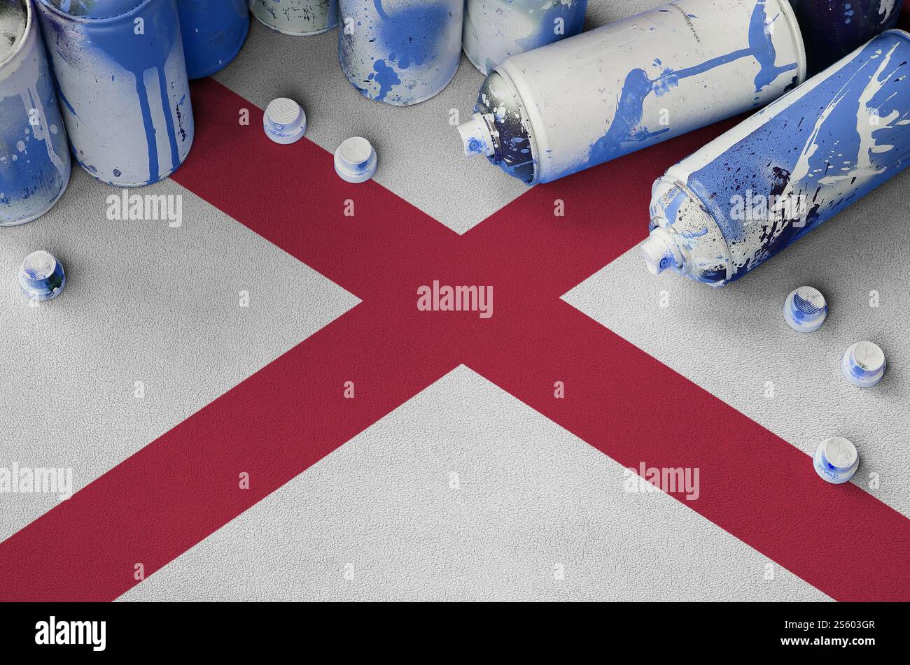 Alabama US state flag and few used aerosol spray cans for graffiti ...