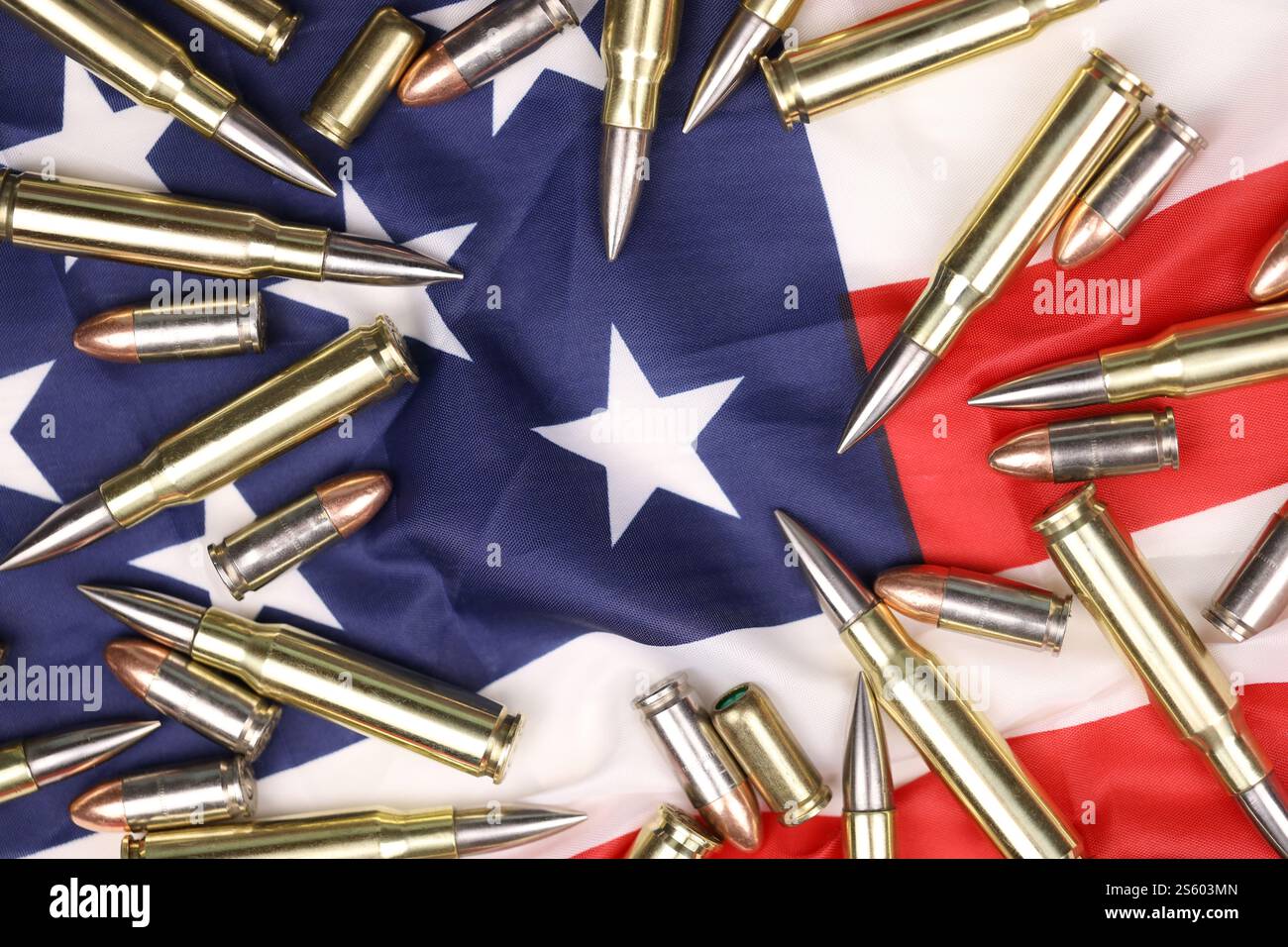 Many yellow 9mm and 5.56mm bullets and cartridges on United States flag ...