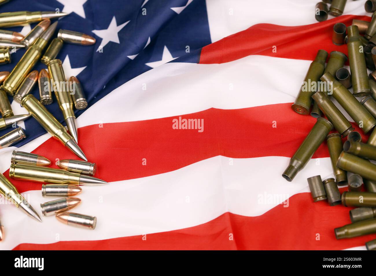 Many yellow 9mm and 5.56mm bullets and cartridges on United States flag ...