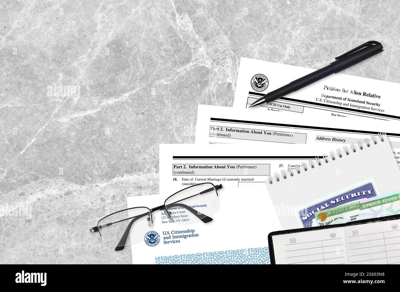 USCIS form I-130 petition for alien relative lies on flat lay office ...