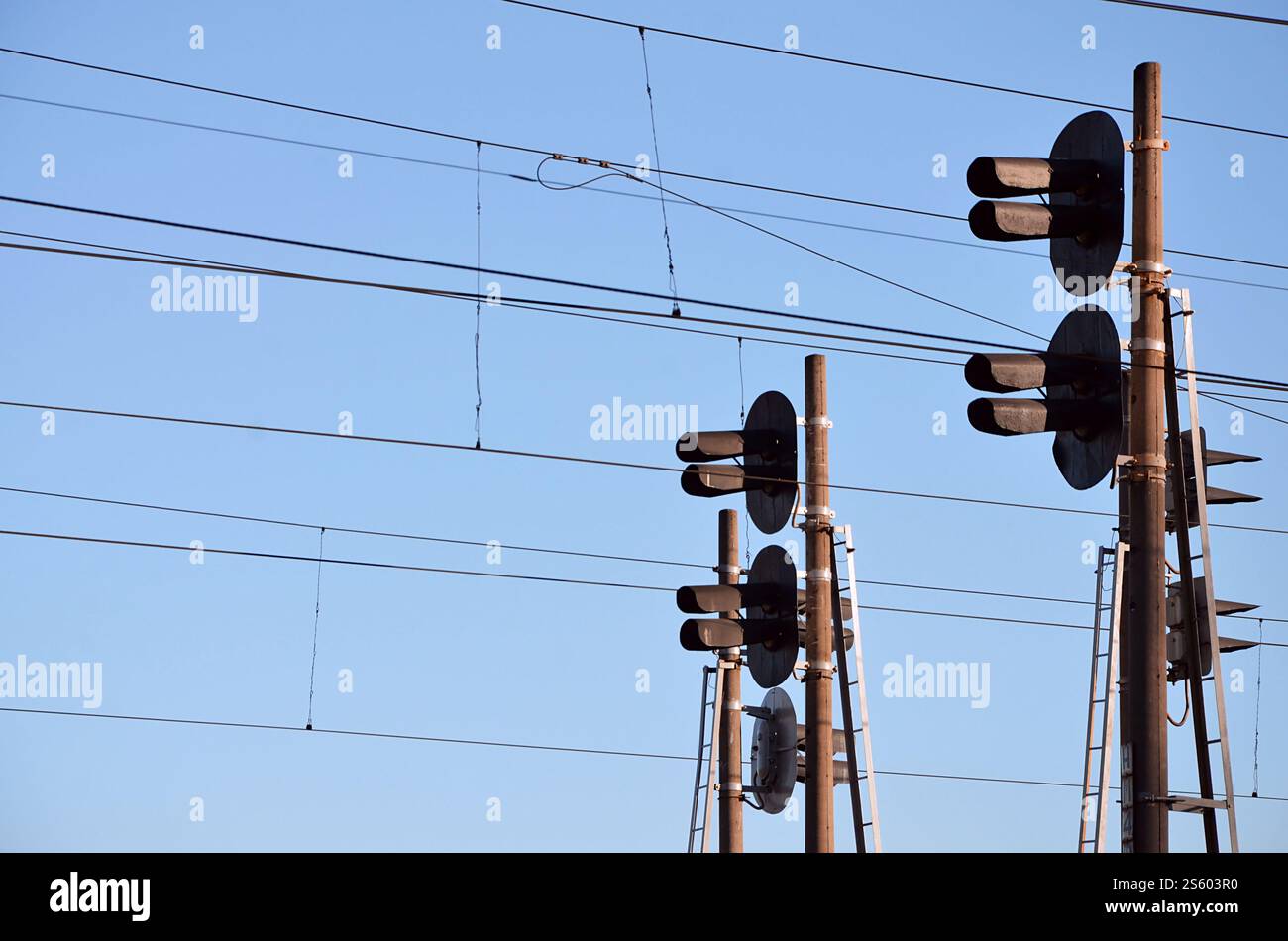 Railroad traffic light against clear blue sky, Contact wire. High ...