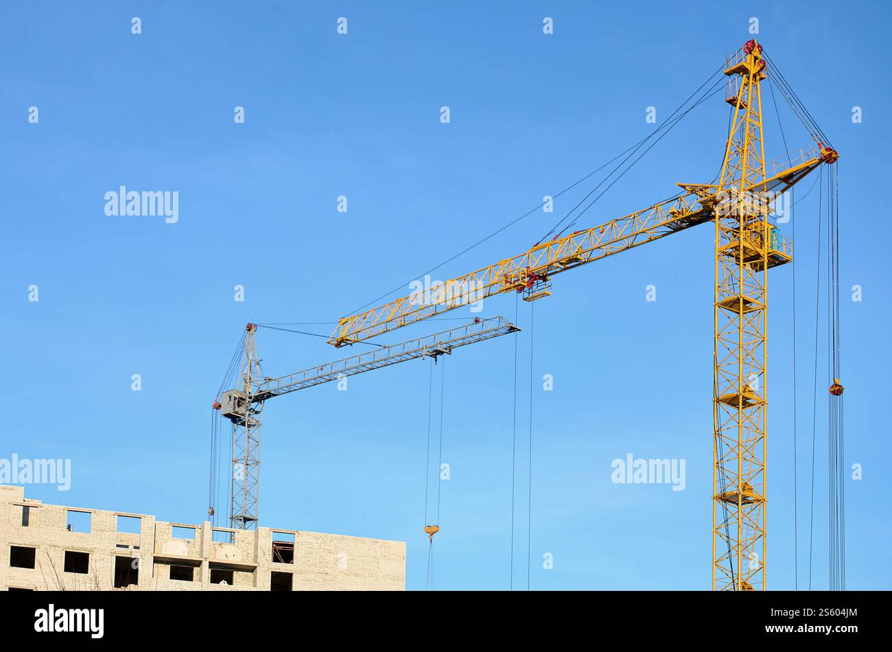 Working tall cranes inside place for with tall buildings under ...