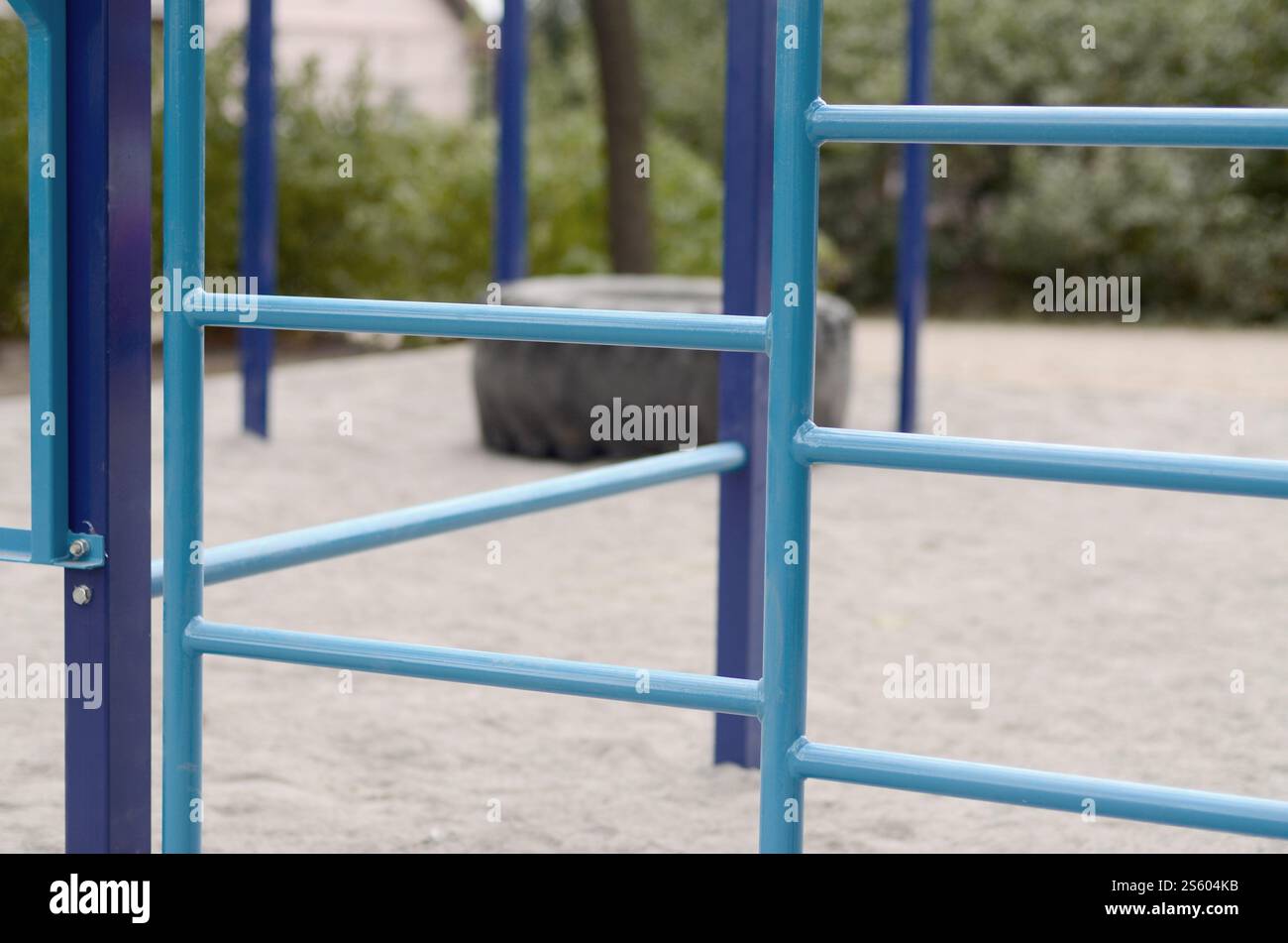 Blue metal pipes and cross-bars against a street sports field for ...