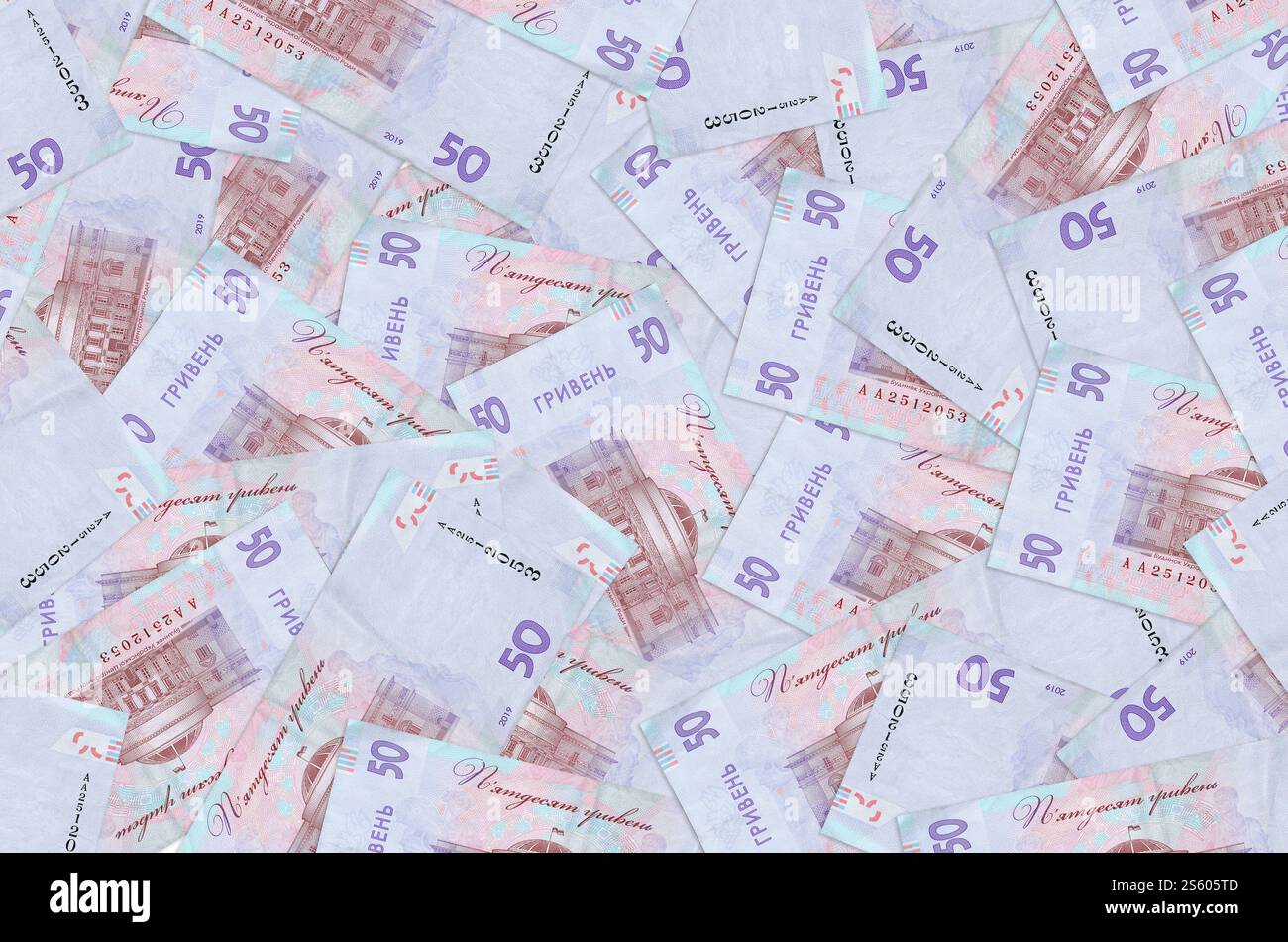 50 Ukrainian hryvnias bills lies in big pile. Rich life conceptual ...