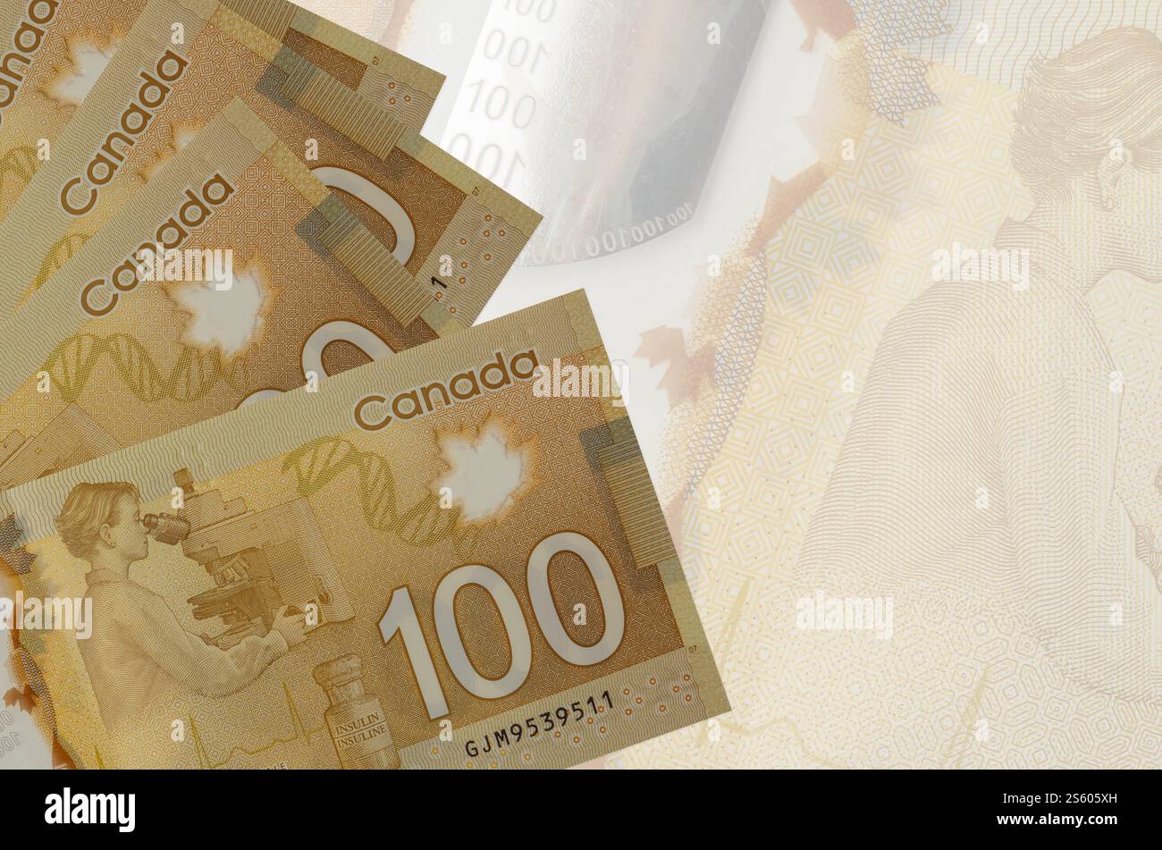 100 Canadian dollars bills lies in stack on background of big semi ...