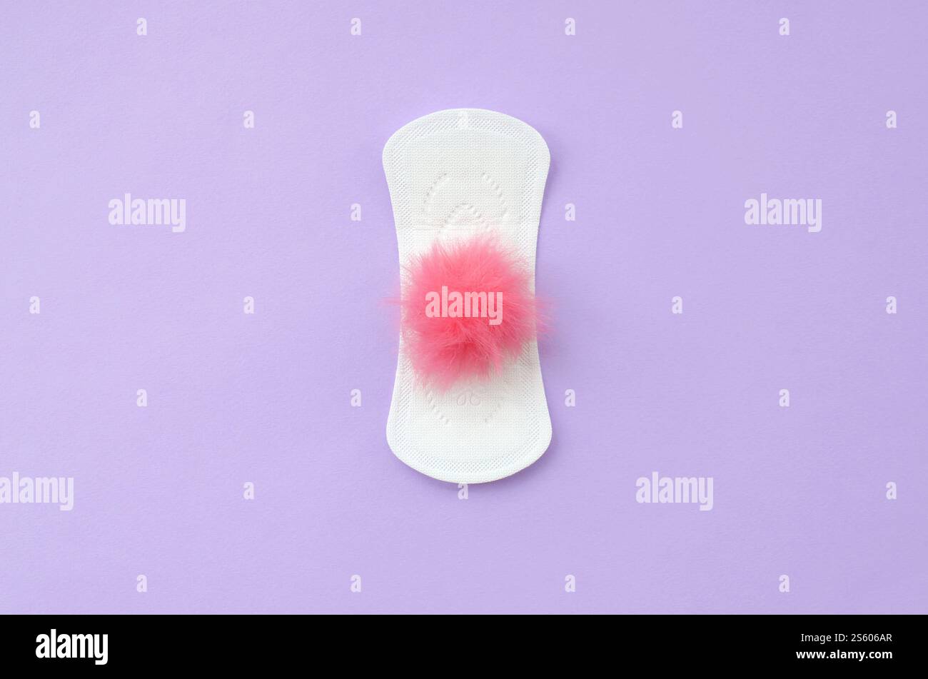 Menstrual pad and red fluffy fuzzy as a blood on violet pastel ...