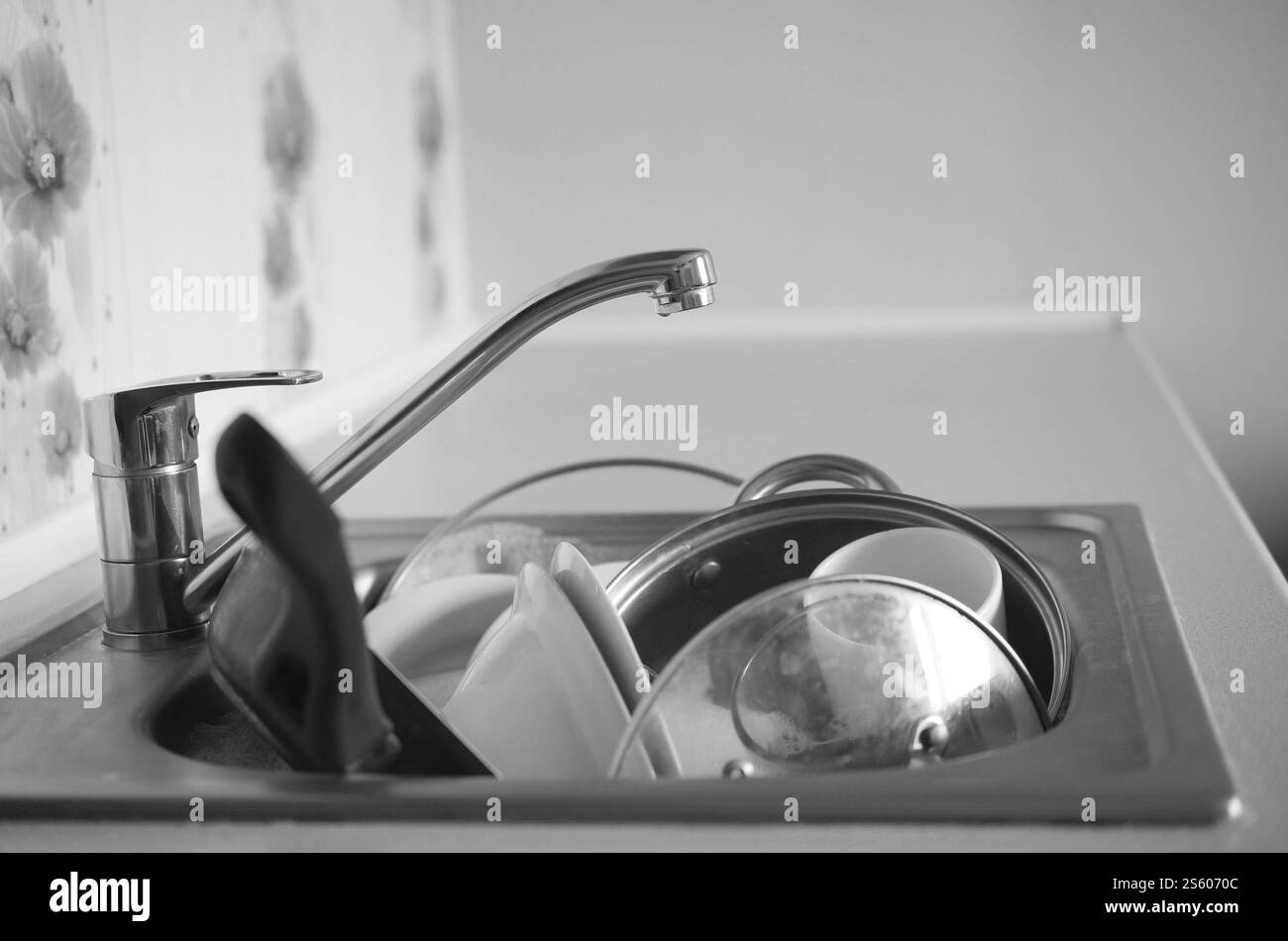 Dirty dishes and unwashed kitchen appliances filled the kitchen sink ...