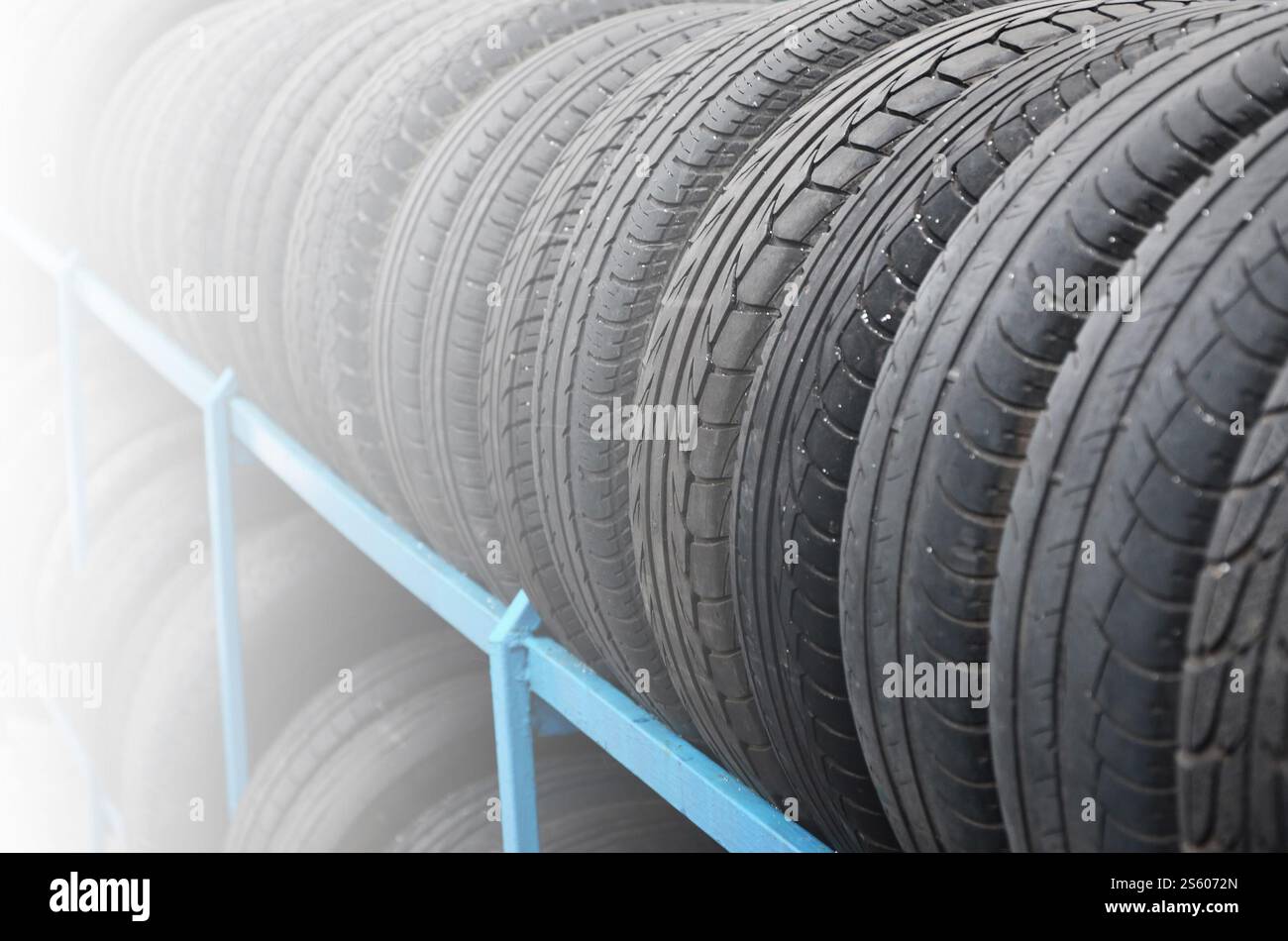 Rack with variety of car tires in automobile store. Many black tires ...