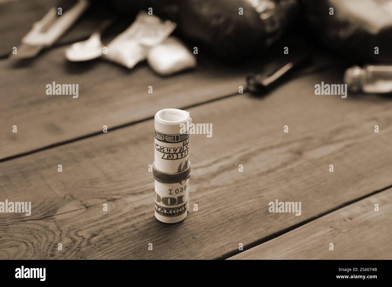 Roll of hundred dollar bills on background of narcotic drug dealer ...