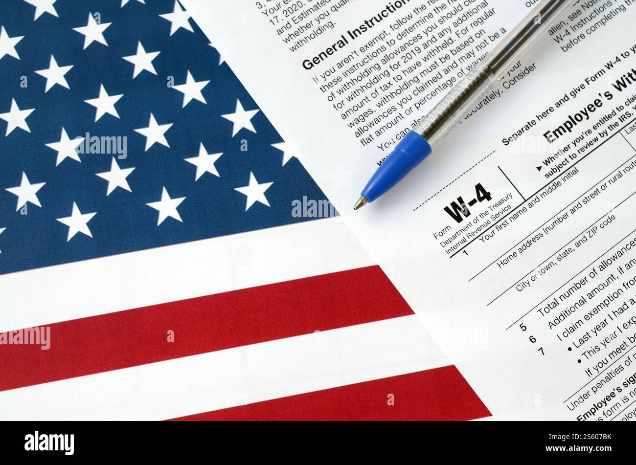 Form W-4 Employees withholding allowance certificate and blue pen on ...